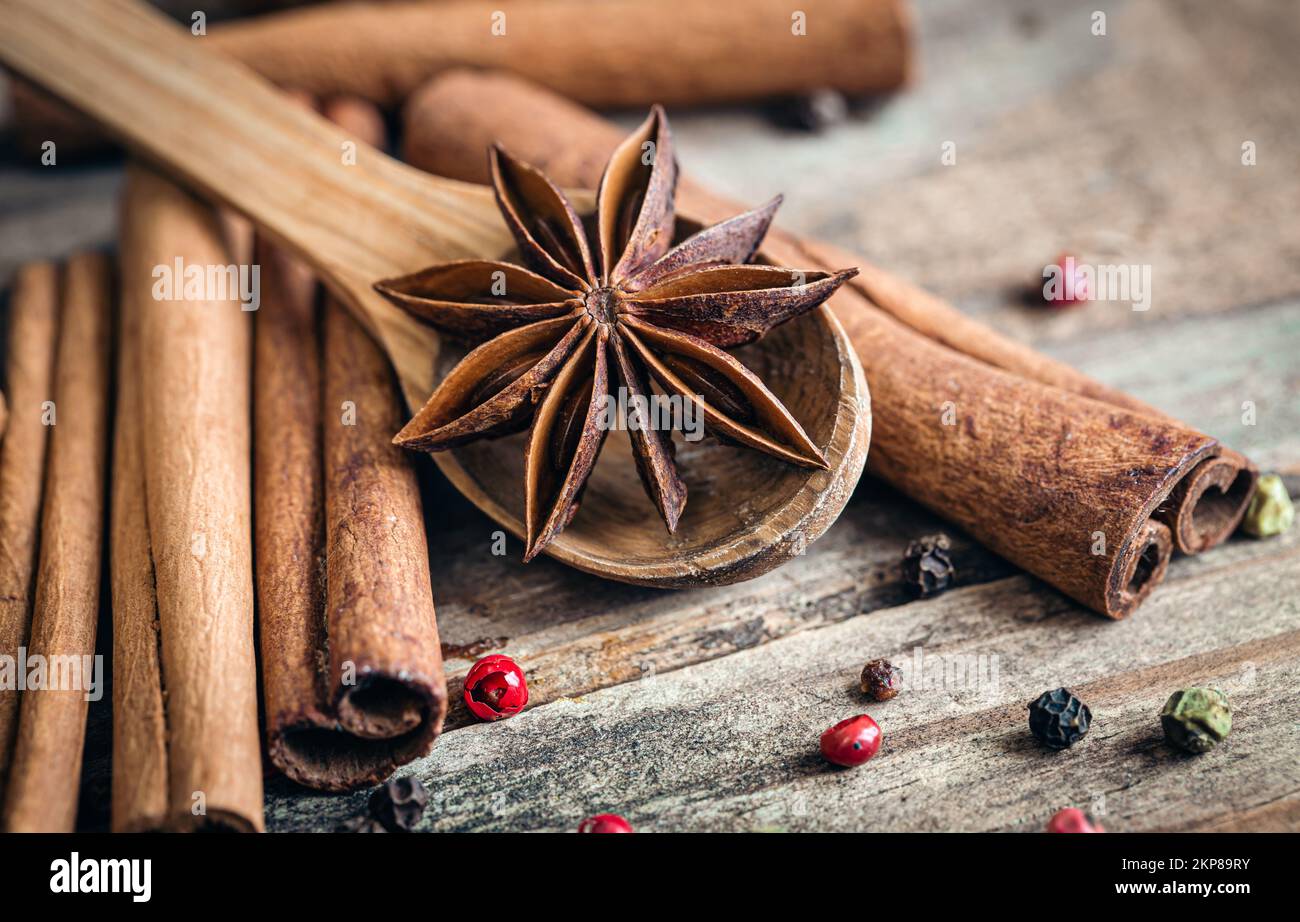 Composition with star anise and cinnamon sticks on a wooden background ...