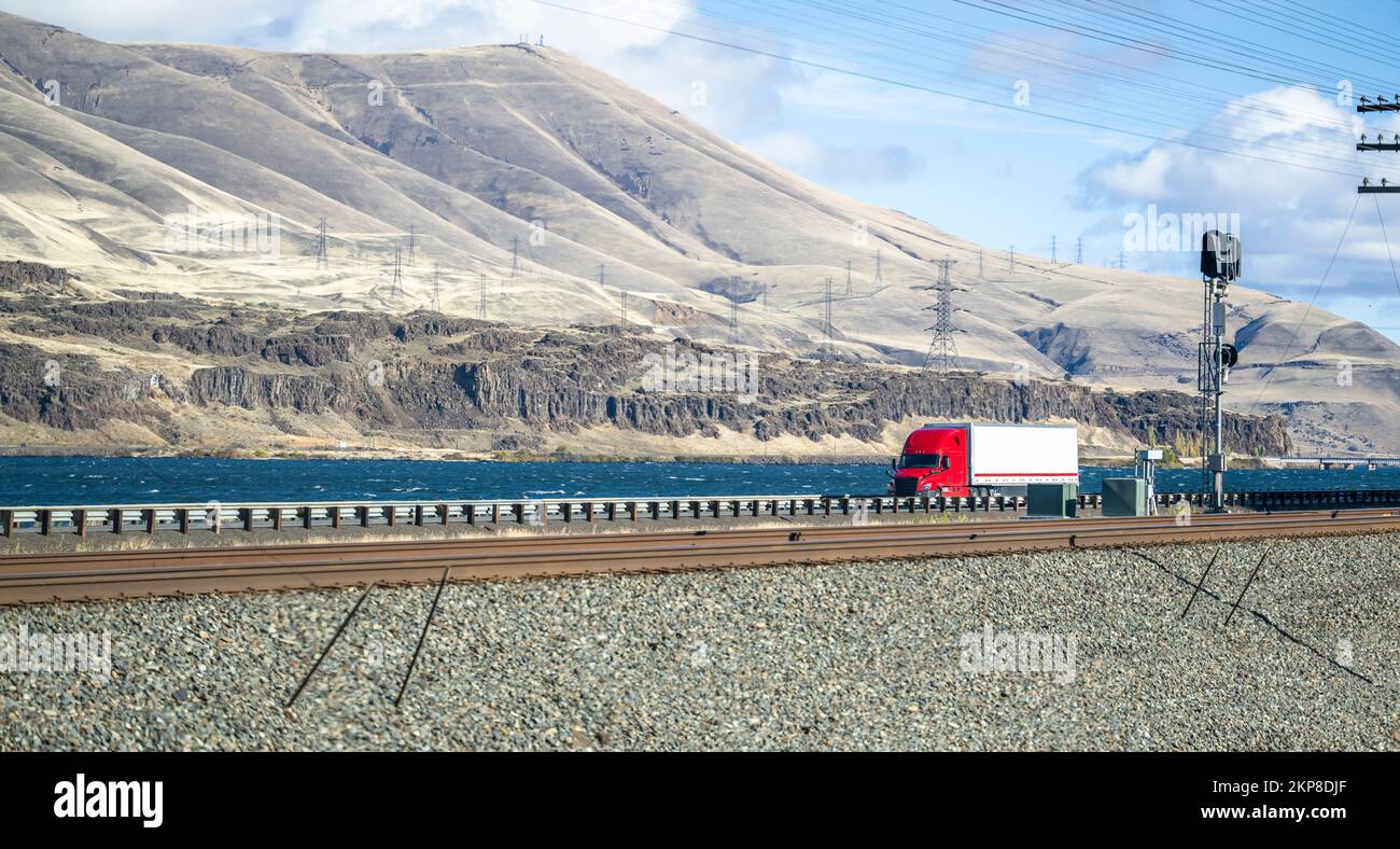 Industrial blue long haul big rig semi truck tractor transporting cargo ...