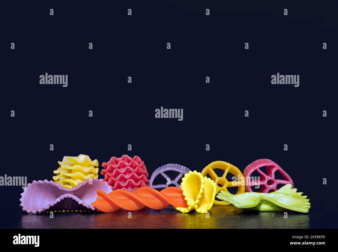 Colourful pasta in different shapes, food photography with a dark ...