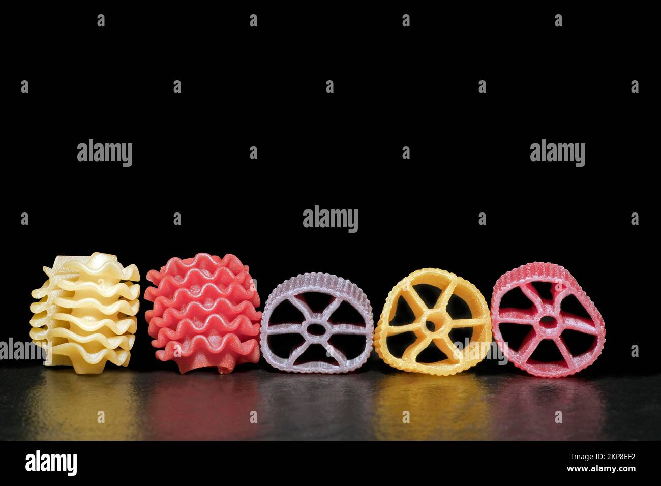 Colourful pasta in different shapes, food photography with a dark ...