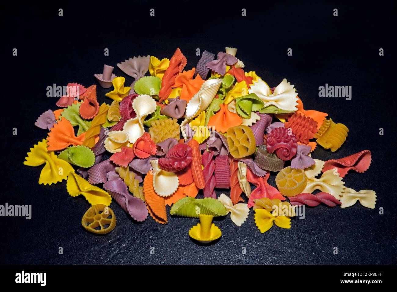Colourful pasta in different shapes, food photography with a dark ...