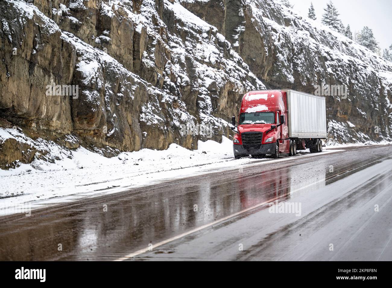Red big rig commercial semi truck transporting cargo in dry van semi ...