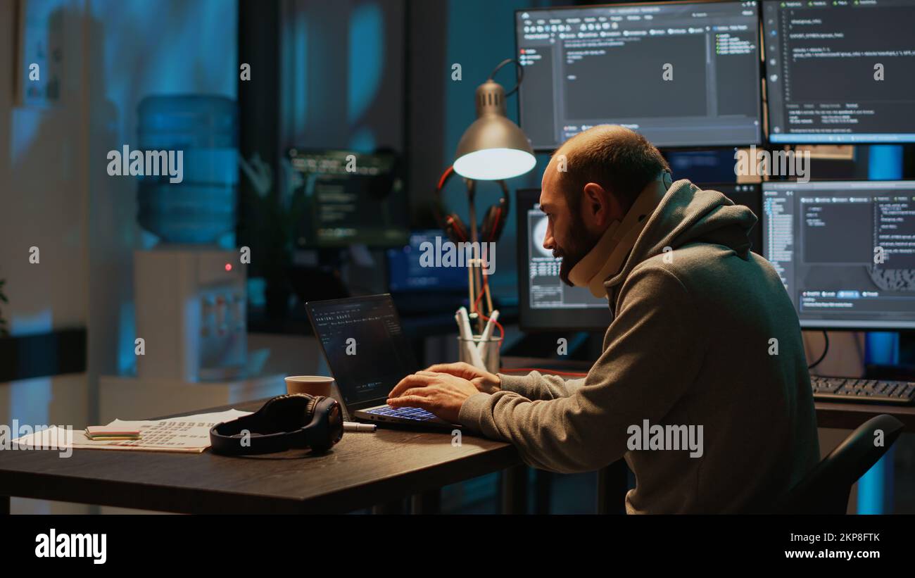 Male employee wearing cervical neck collar at app developing job ...