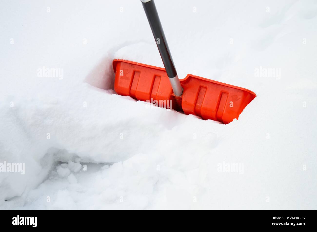 Red plastic shovel with black handle Stock Photo - Alamy