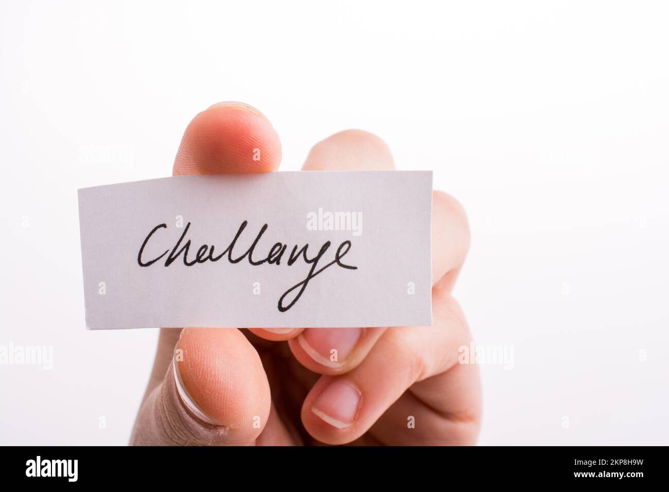 Hand holding a challenge written paper on a white background Stock ...