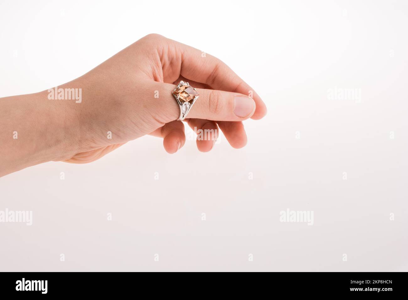 Hand wearing a ring on a white background Stock Photo - Alamy