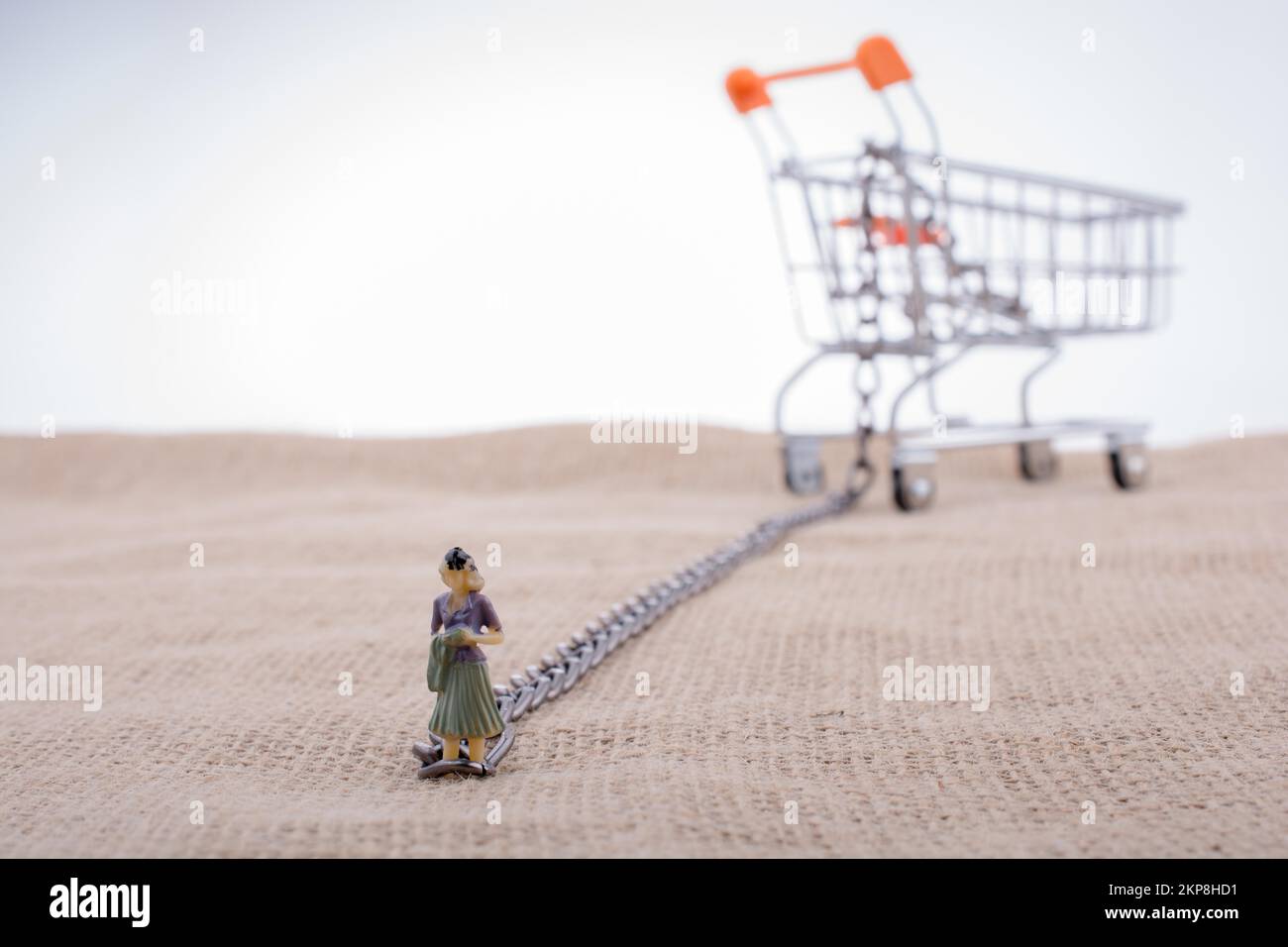 Woman figurine attached to a Shopping cart with chain Stock Photo - Alamy