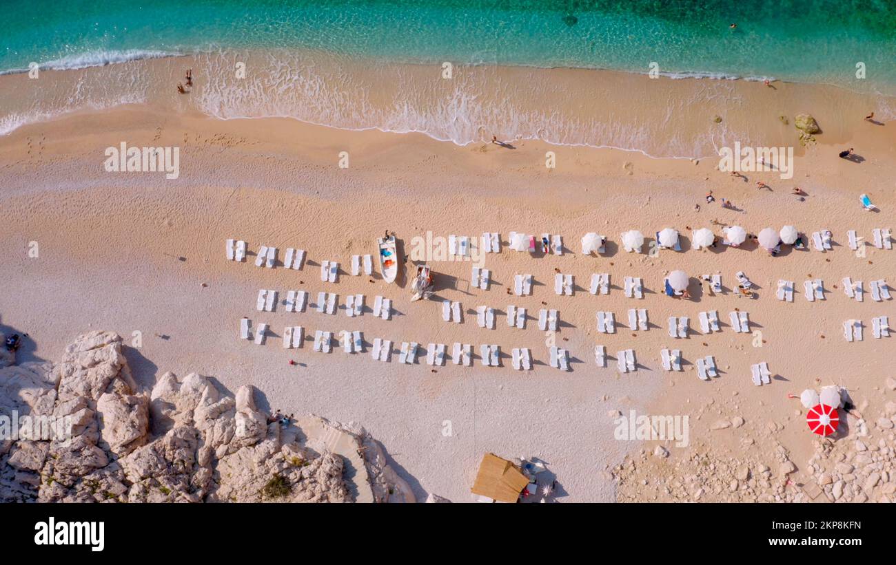 Top view tourists enjoying vacation on sandy beach of tropical island ...