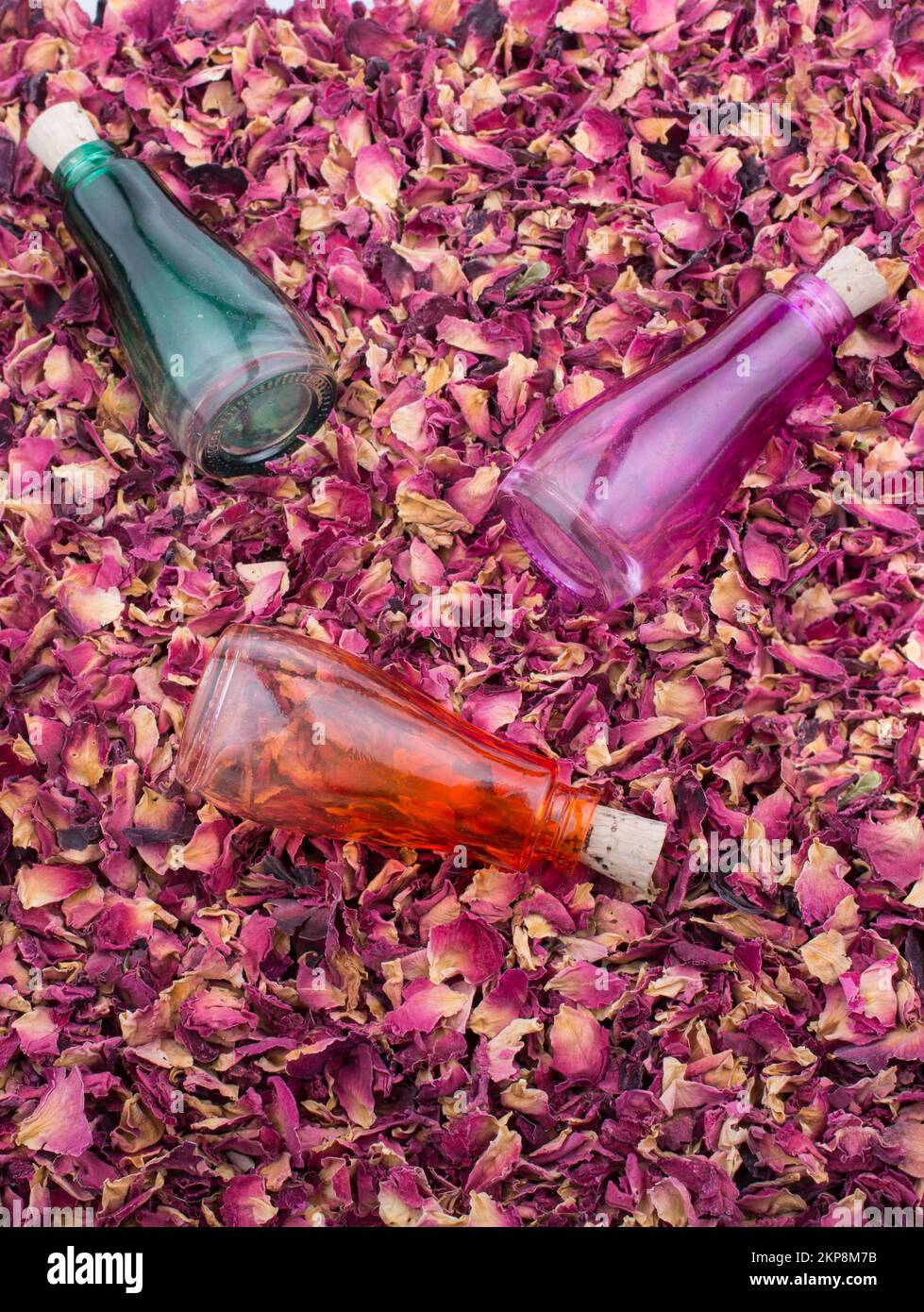 Colorful empty bottles on dry rose petal background Stock Photo - Alamy