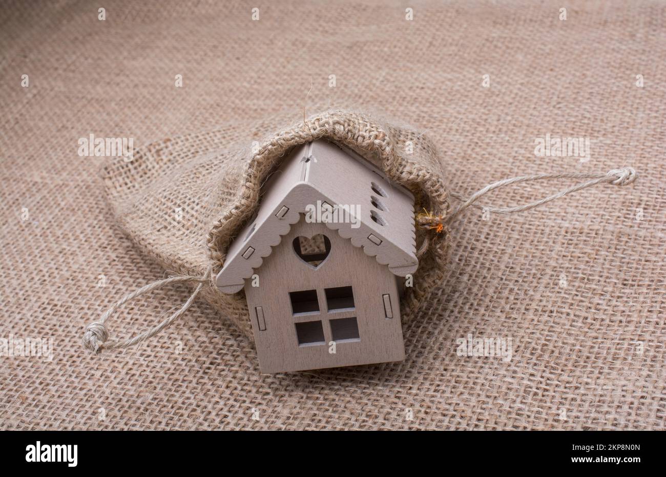 Model house beside a sack on a canvas background Stock Photo - Alamy