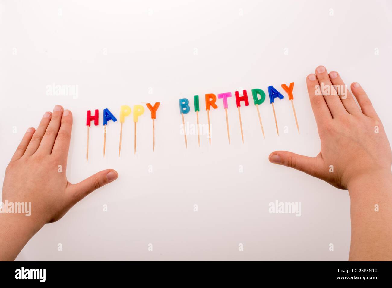 Hand and color candles on sticks write the words happy birthday Stock ...