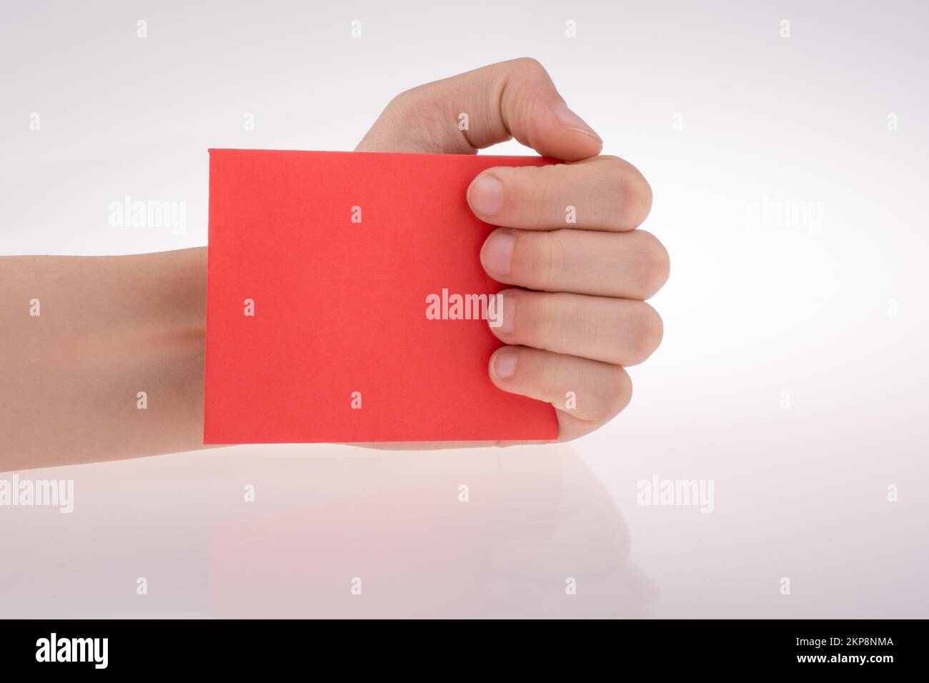Hand holding a red note paper on white background Stock Photo - Alamy