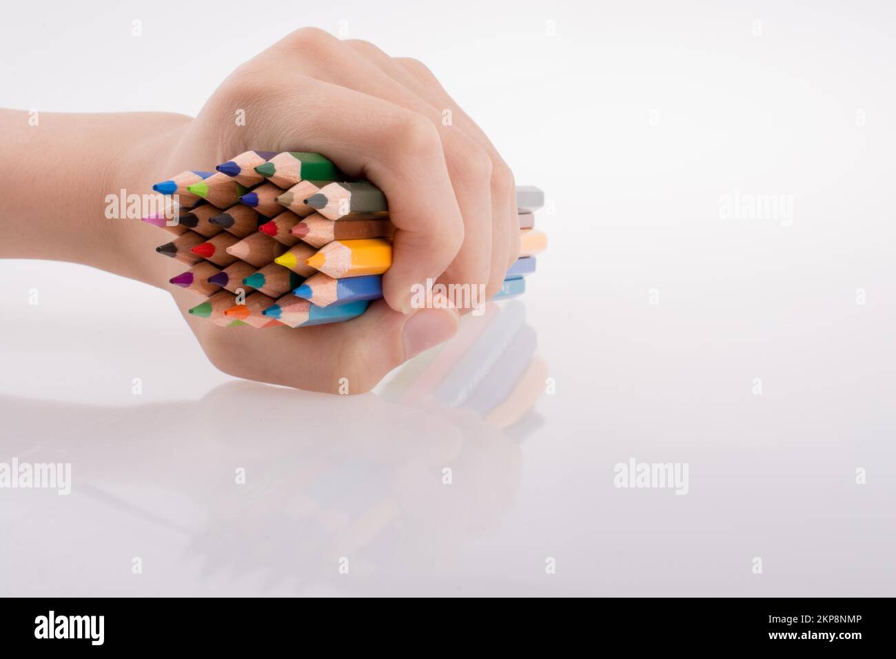 Hand holding color pencils on a white background Stock Photo - Alamy