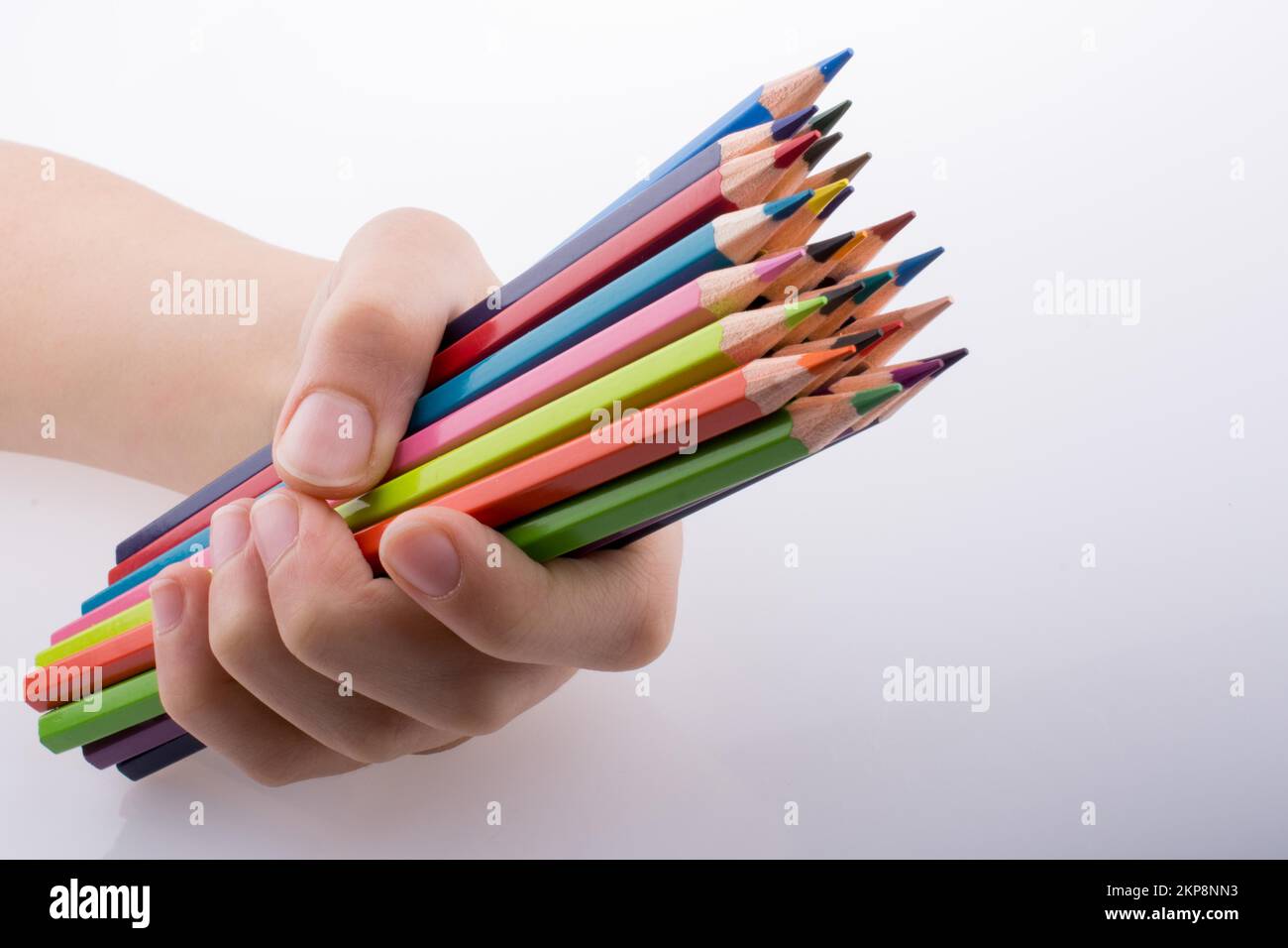 Hand holding color pencils on a white background Stock Photo - Alamy