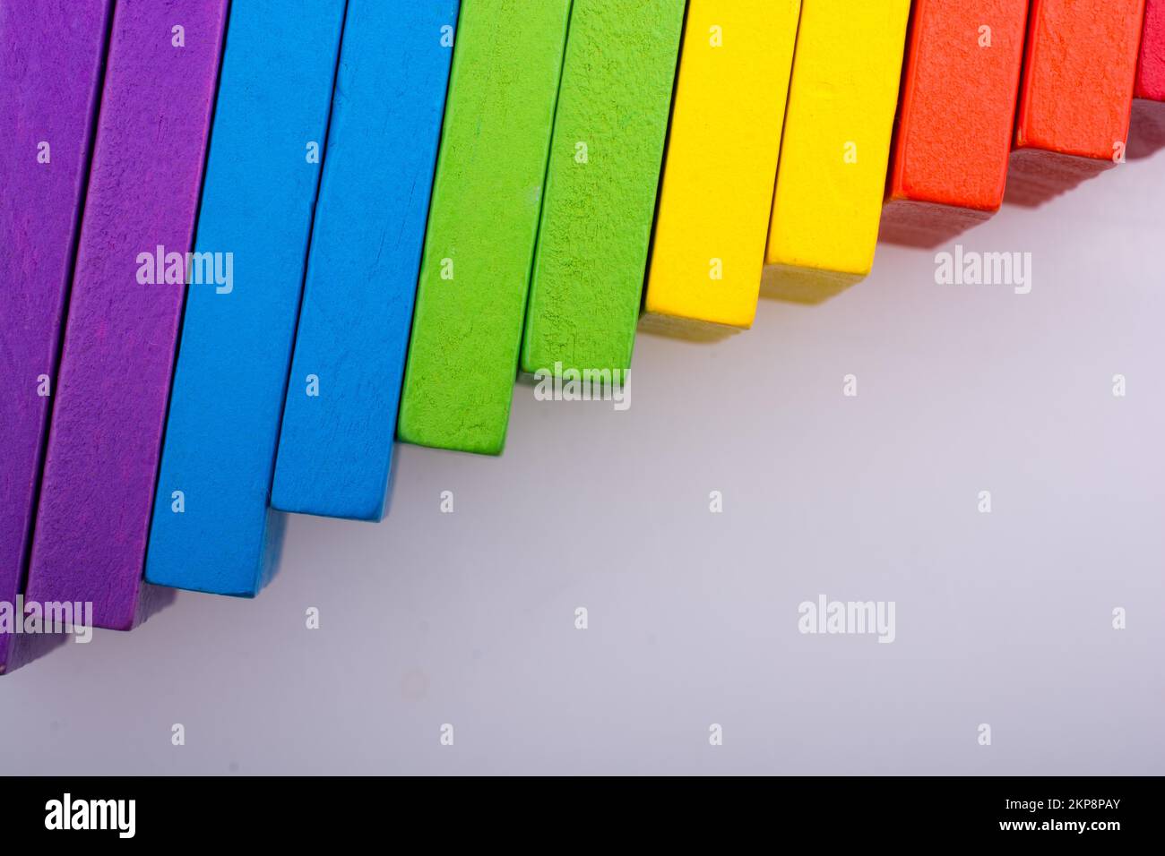 Colorful Domino Blocks in a line on a white background Stock Photo - Alamy