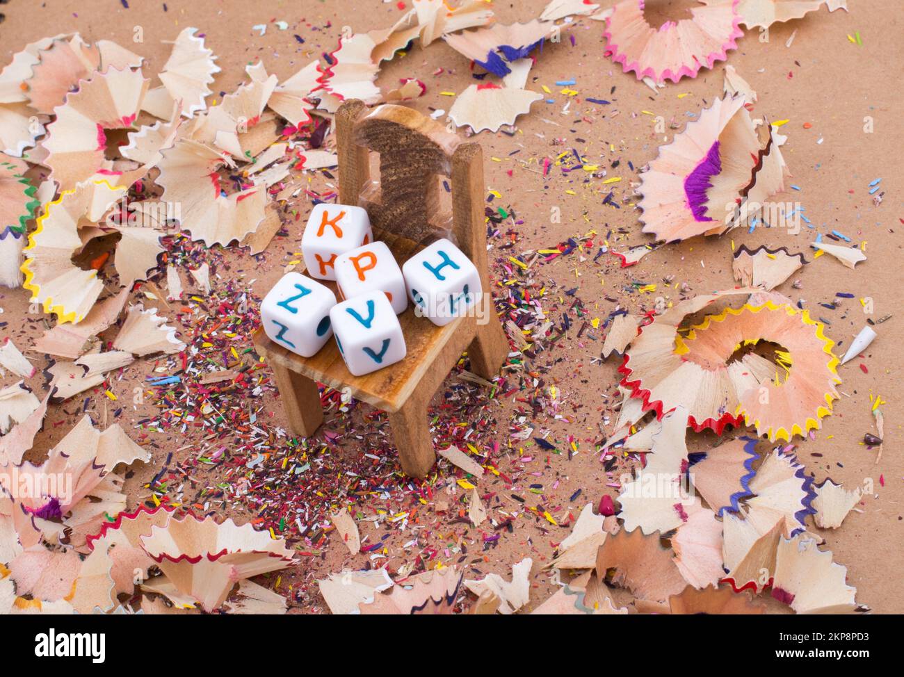Colorful letter cubes on chair in pencil trash Stock Photo - Alamy
