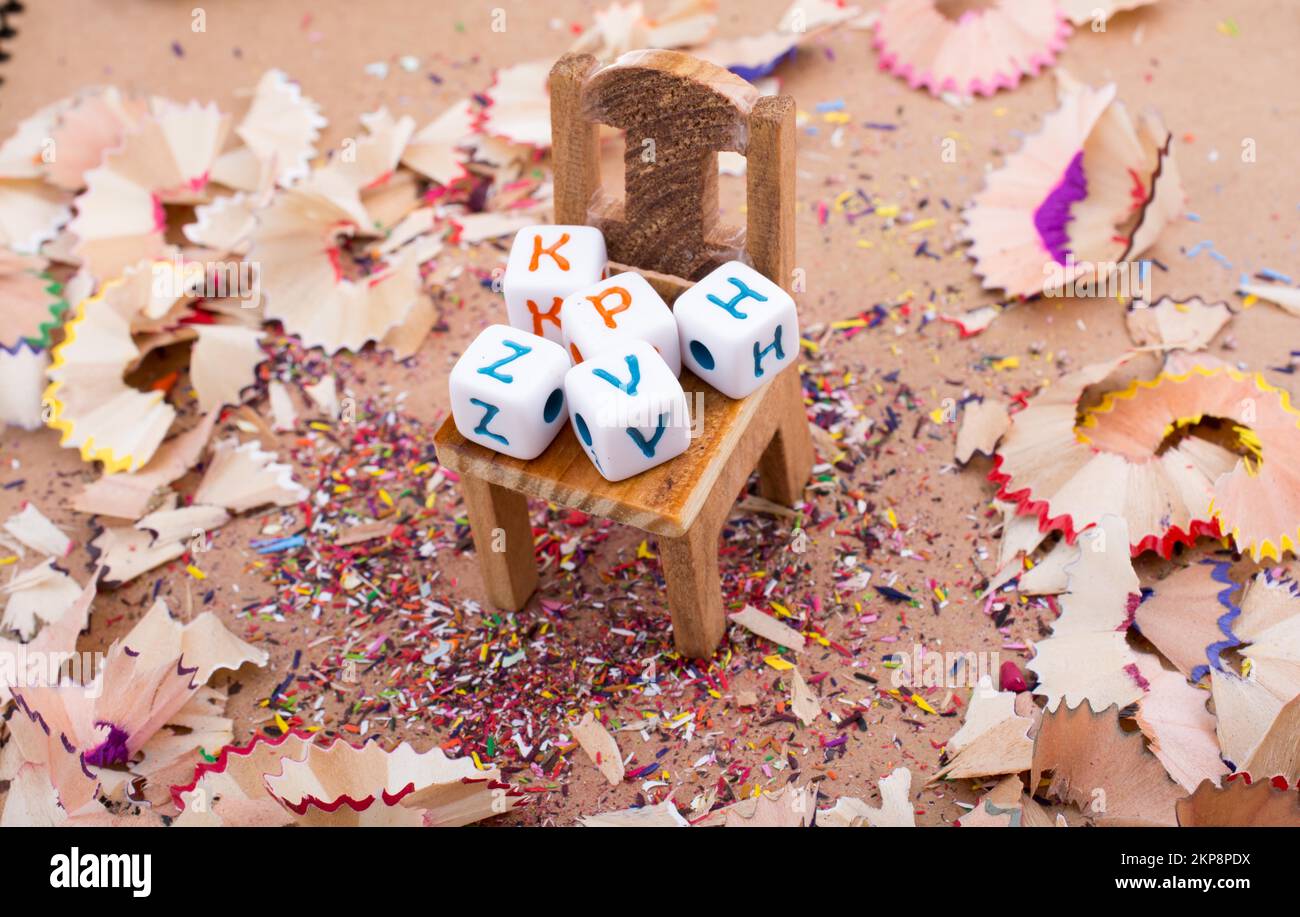 Colorful letter cubes on chair in pencil trash Stock Photo - Alamy