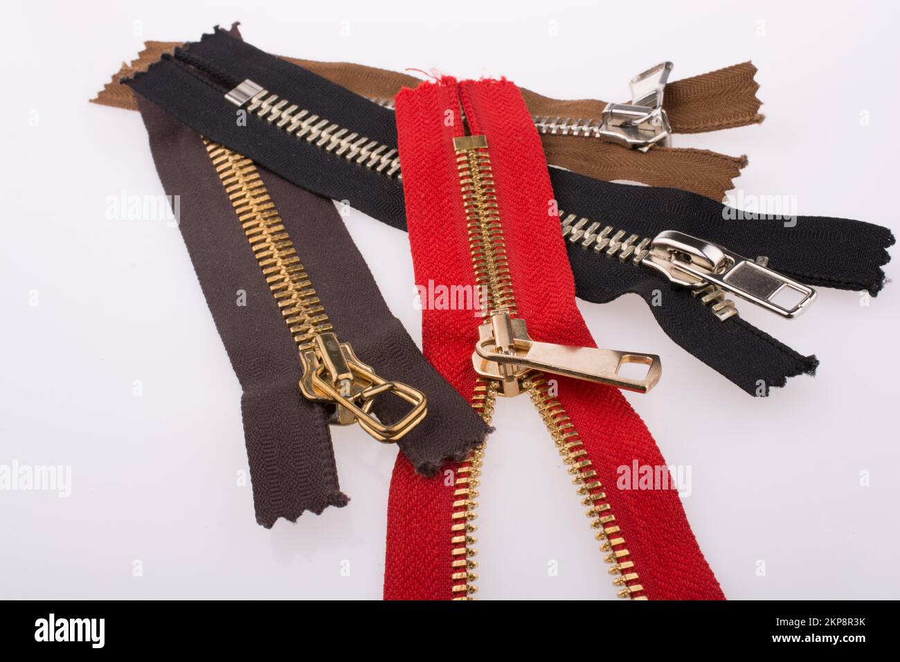 Color zippers on a white background Stock Photo - Alamy
