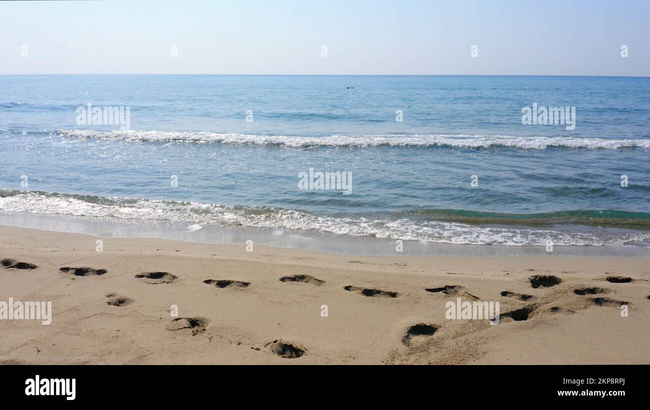 Scenic landscape of calm sea waves on sandy beach on a summer day ...