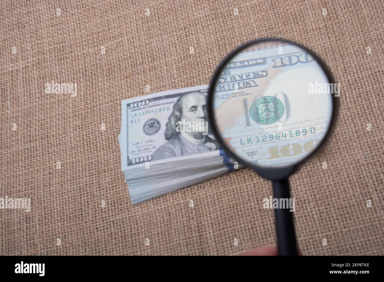Magnifying glass over the banknote bundle of US dollar Stock Photo - Alamy