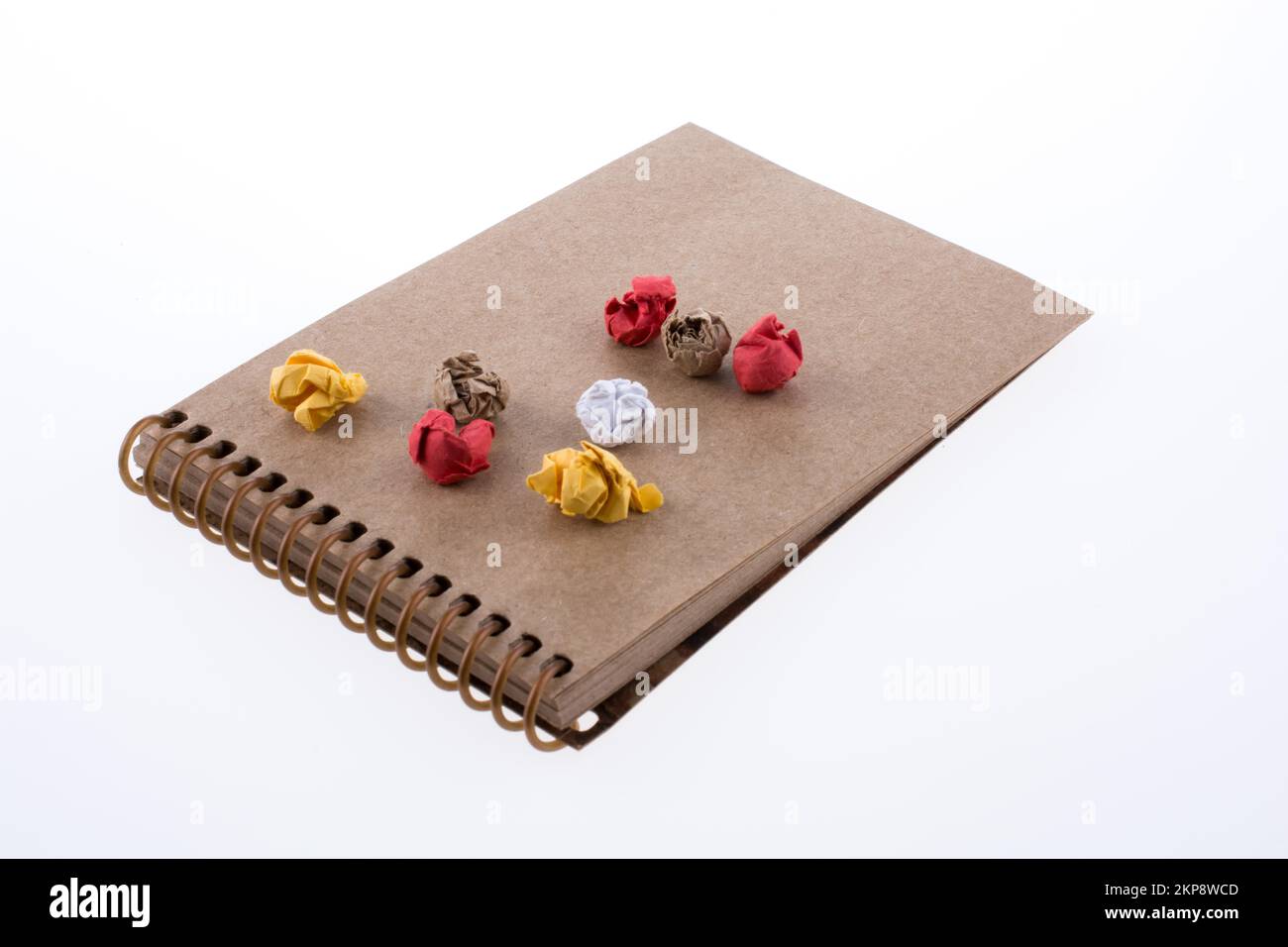 Colorful crumbled paper on a notebook on a white background Stock Photo ...