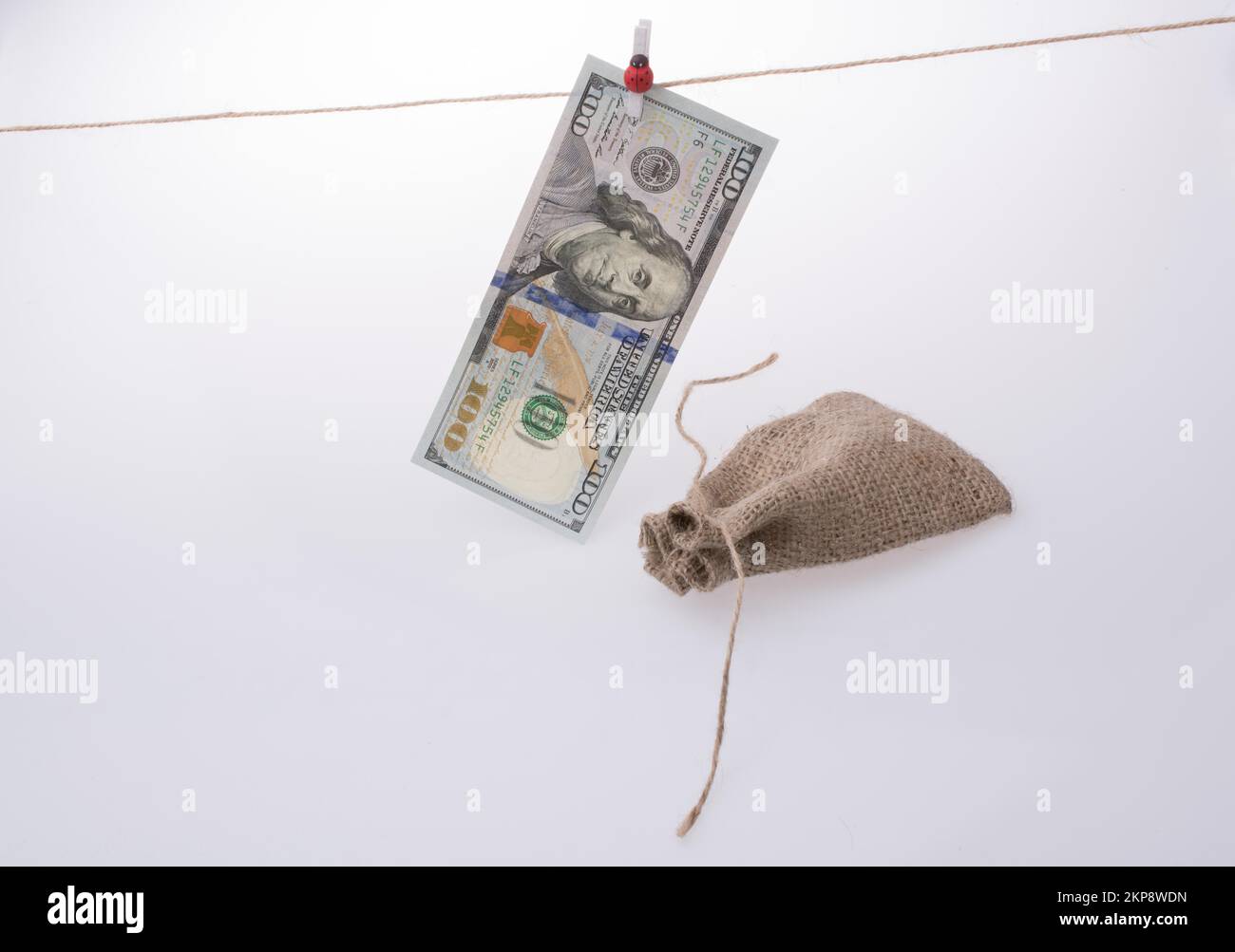 Banknote of US dollar hanging on a linen string Stock Photo - Alamy