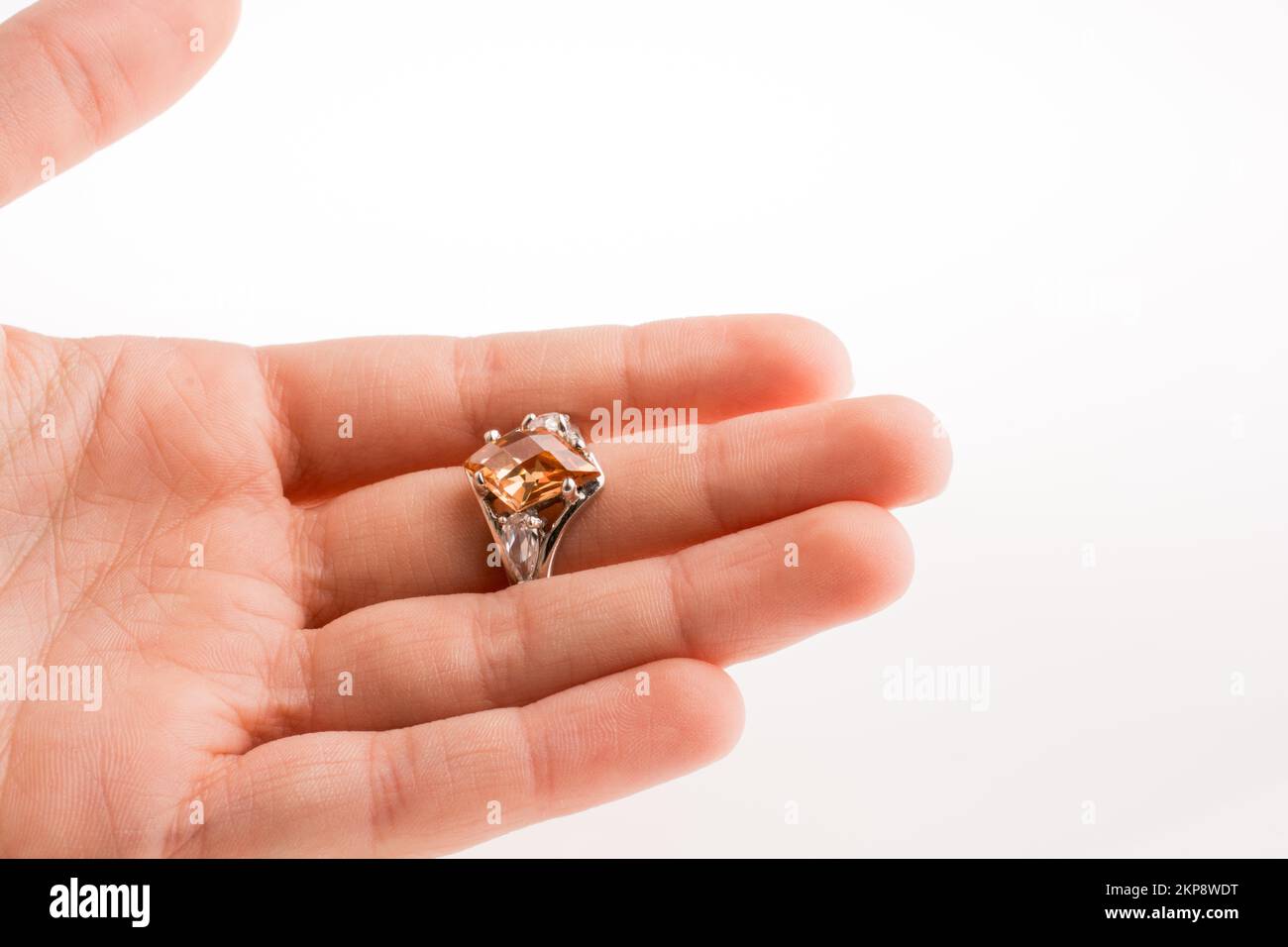 Hand wearing a ring on a white background Stock Photo - Alamy