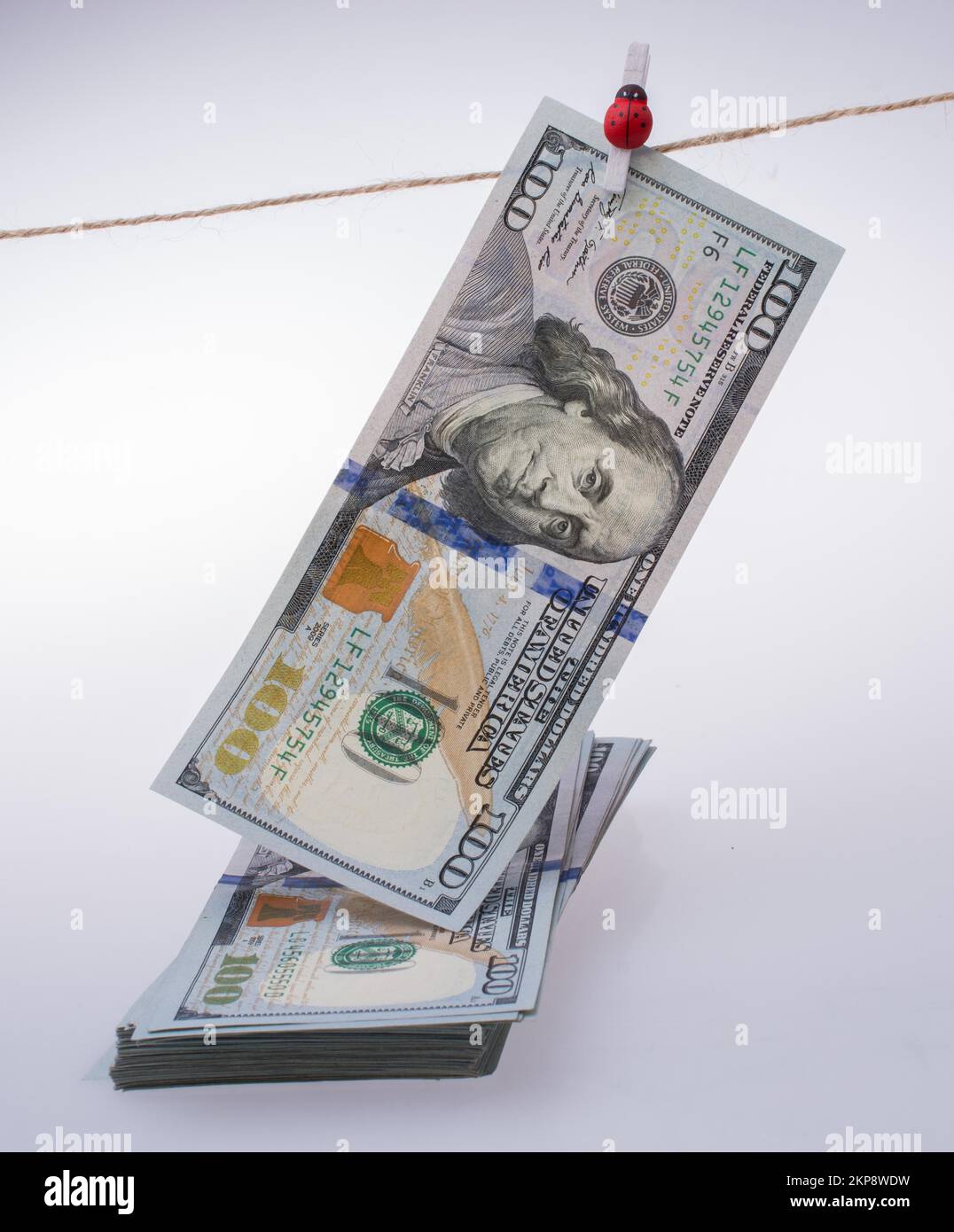Banknote of US dollar hanging on a linen string Stock Photo - Alamy