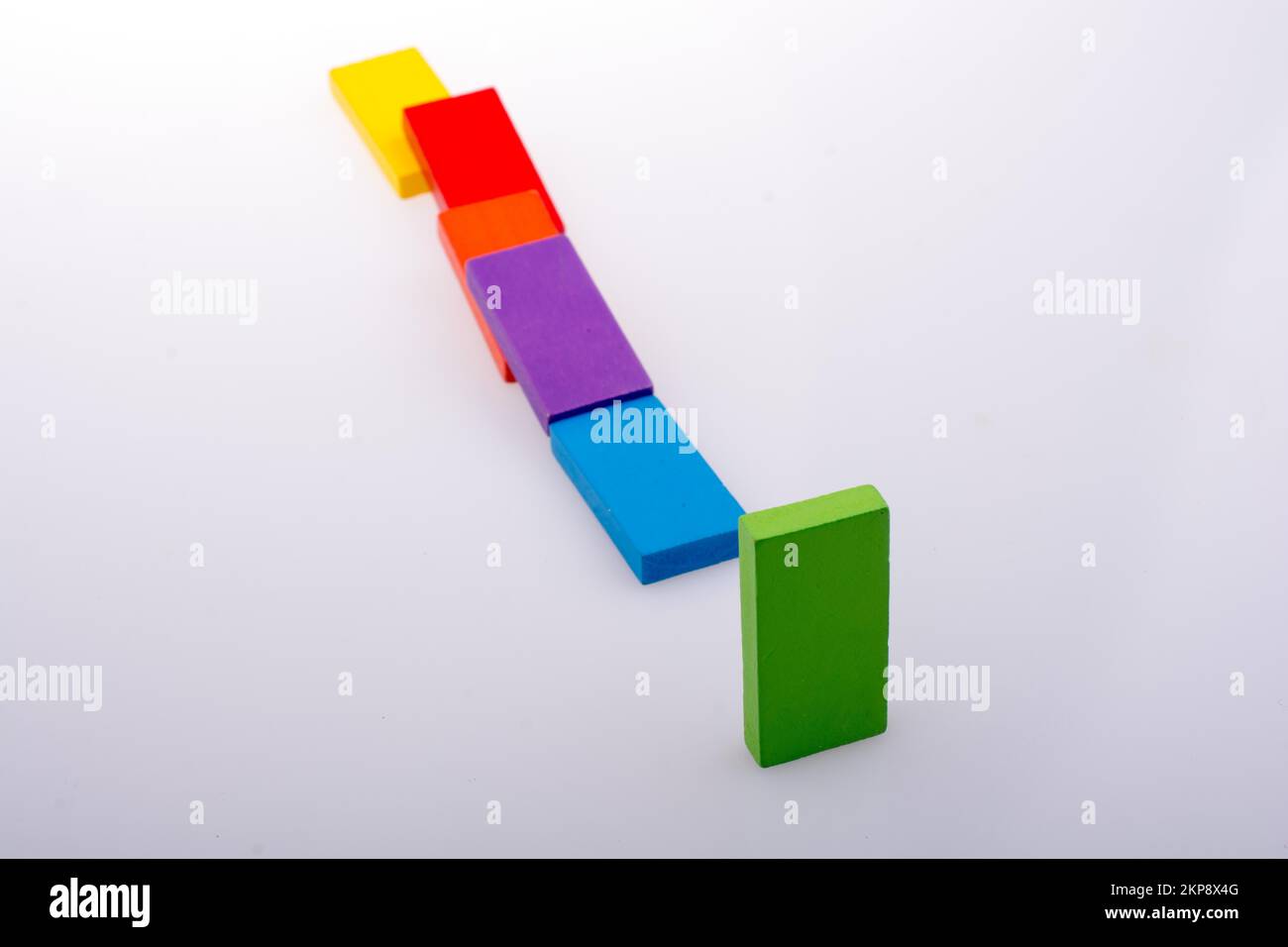 Colorful Domino Blocks in a line on a white background Stock Photo - Alamy