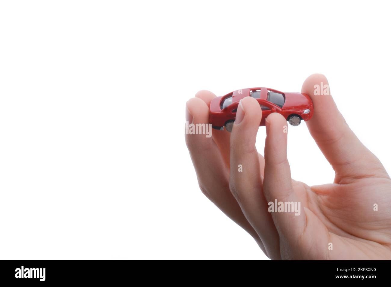 Child's hand holding a red car on a white background Stock Photo - Alamy
