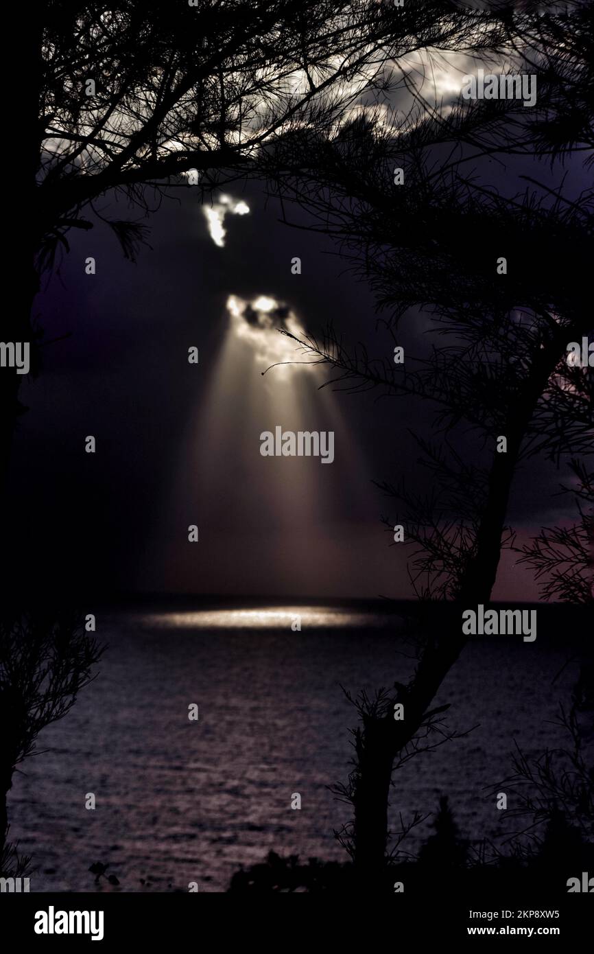 An aerial view of sun rays with reflection on water during sunset Stock ...