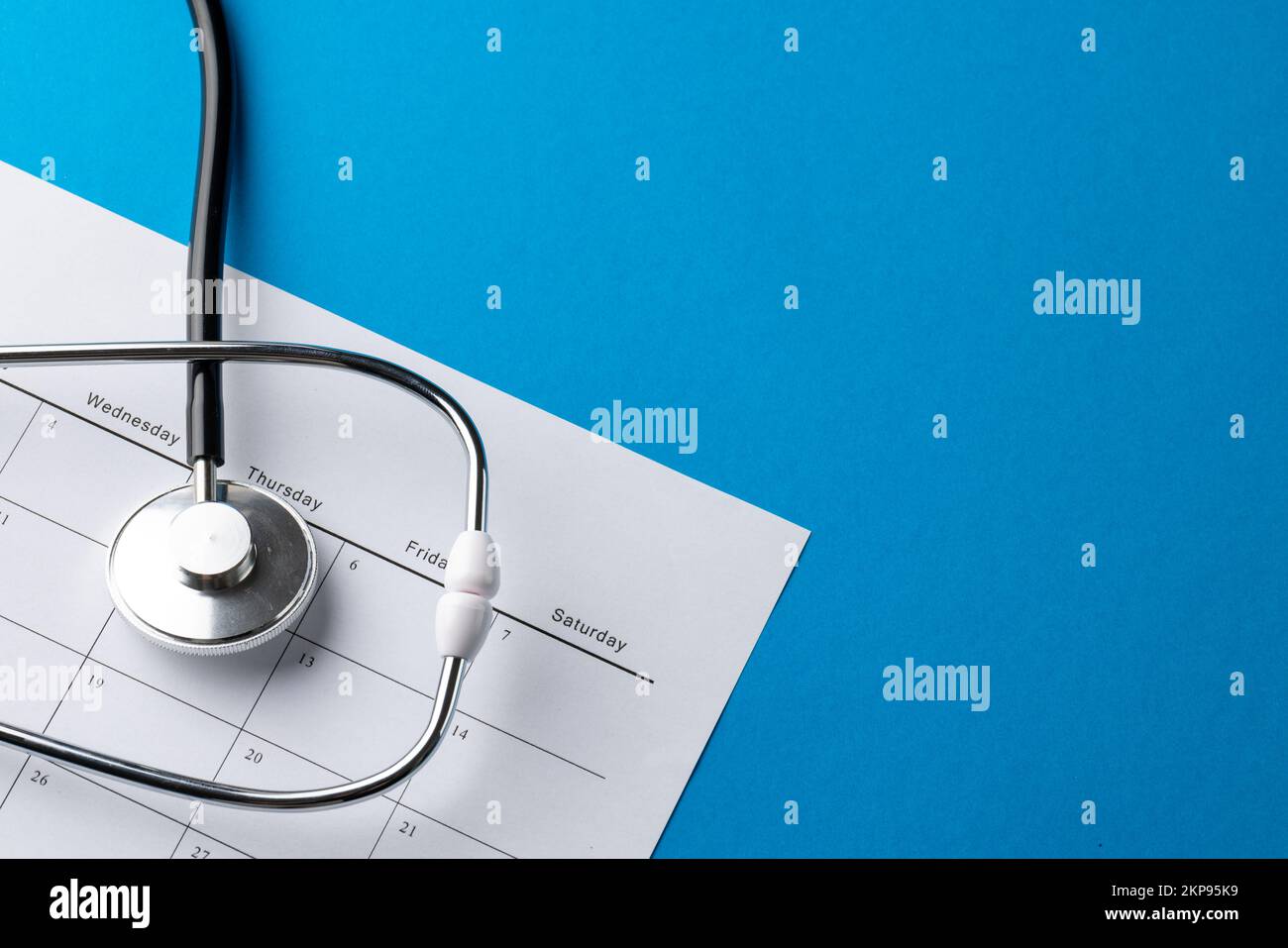 Composition of stethoscope with calendar on blue background with copy ...