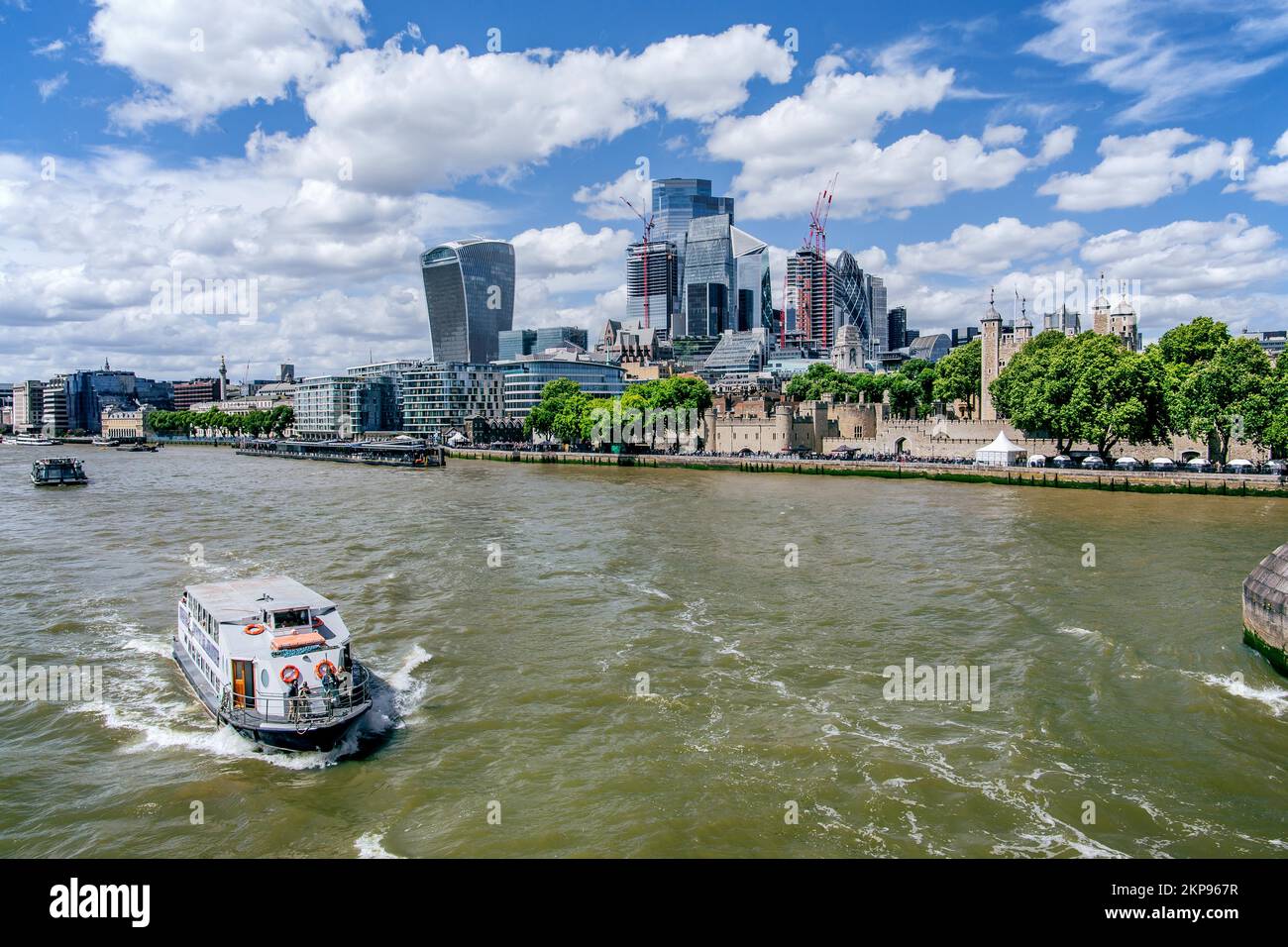 Excursion boat on the Thames with skyline, London, City of London ...