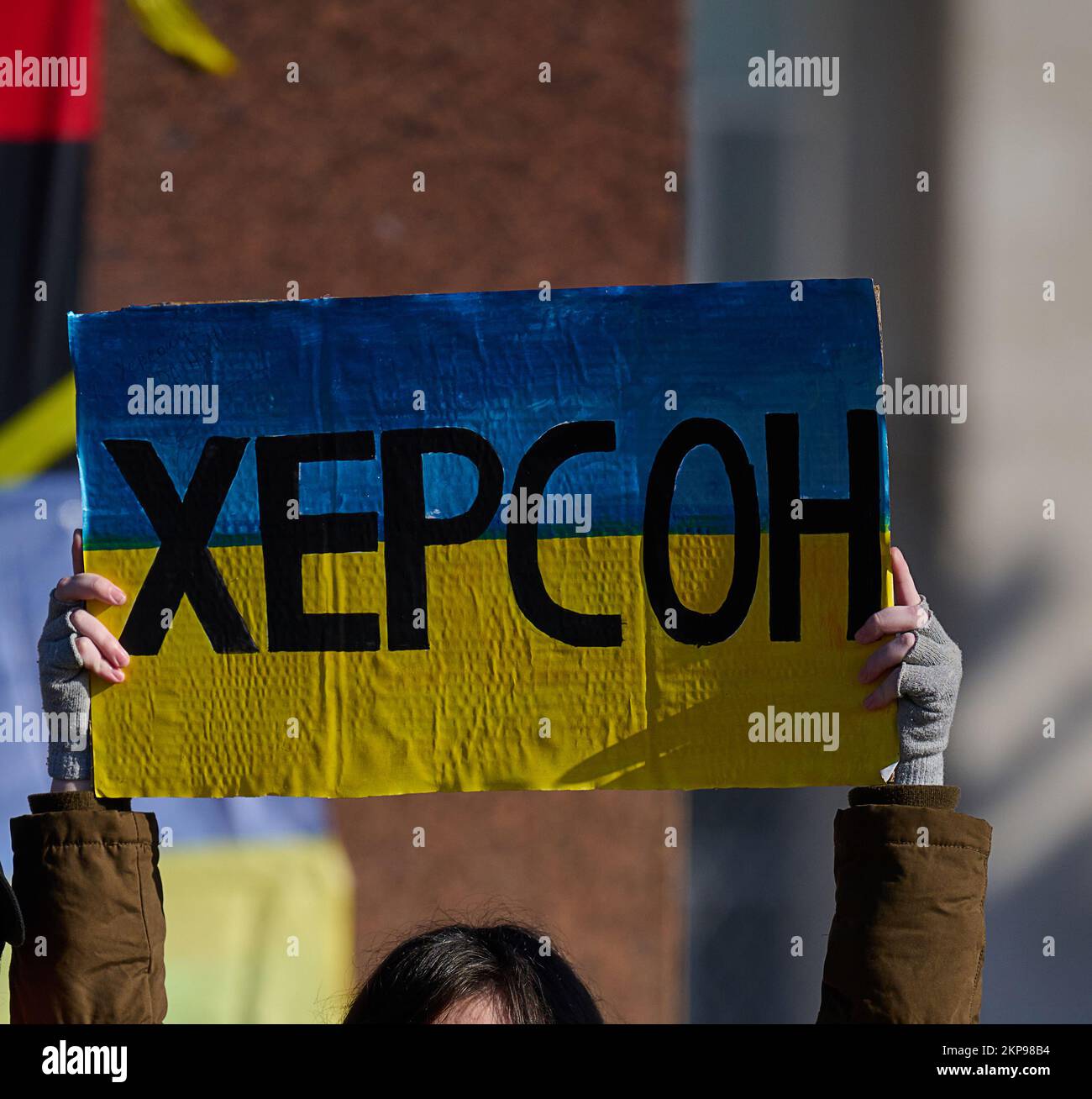 Women's hands hold a poster with the inscription Kherson Stock Photo ...
