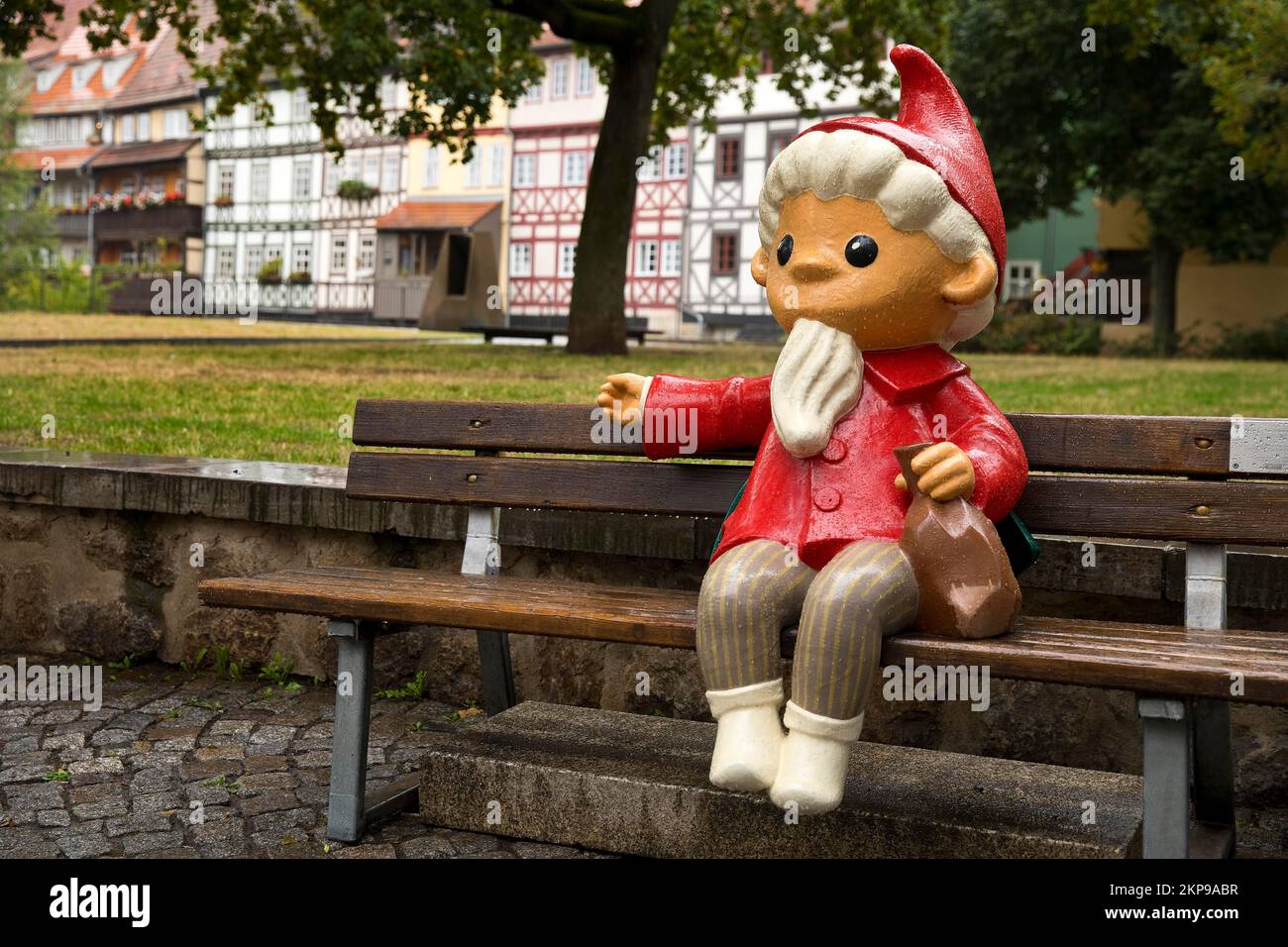 Sculpture of the Sandman on a bench in front of half-timbered houses on ...