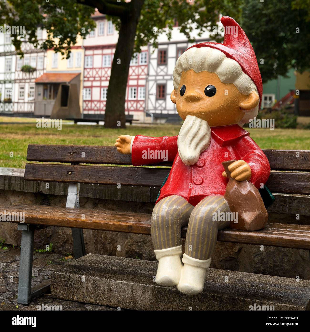 Sculpture of the Sandman on a bench in front of half-timbered houses on ...