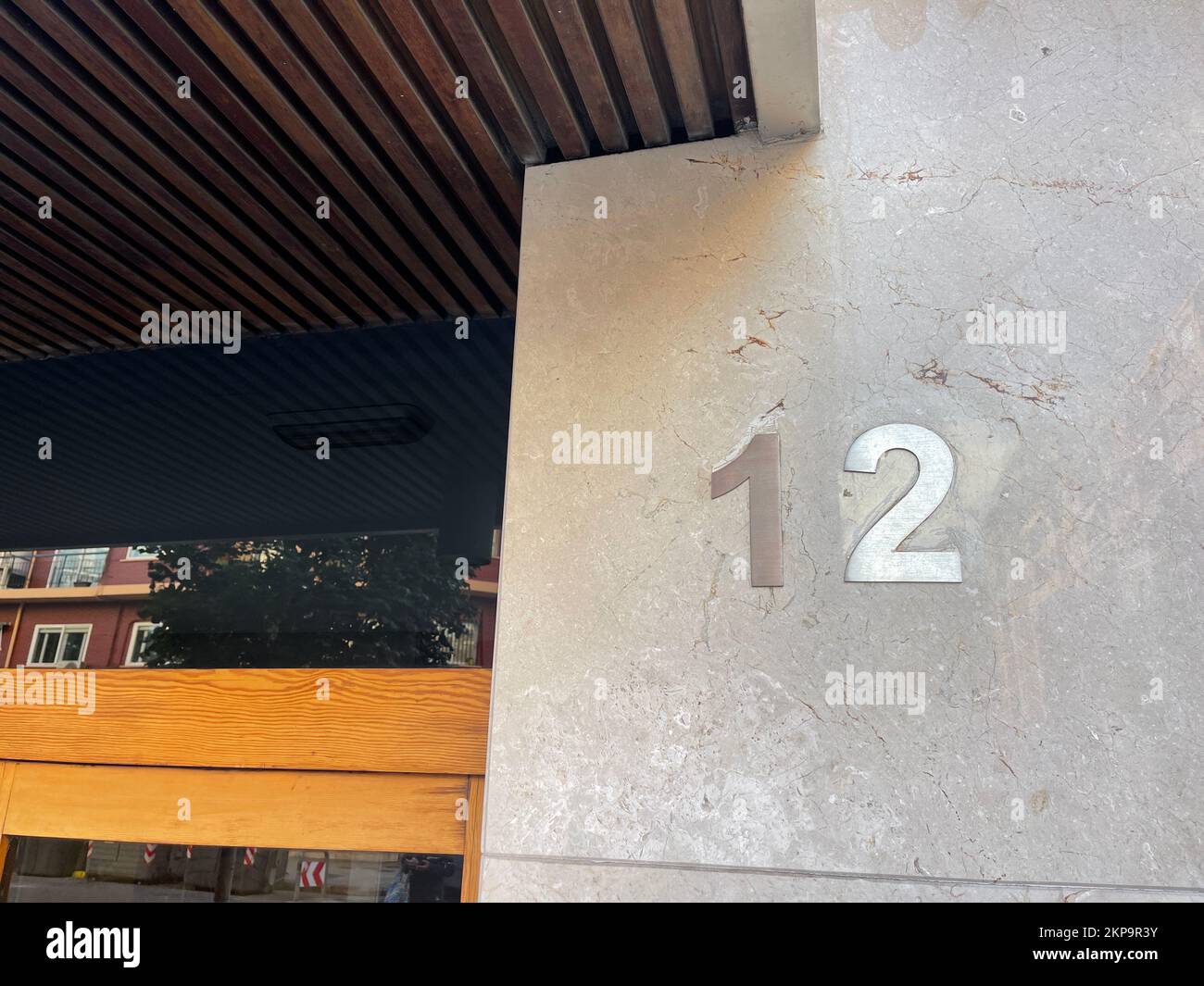 The number 12 on the wall of the house on the right side of the frame ...