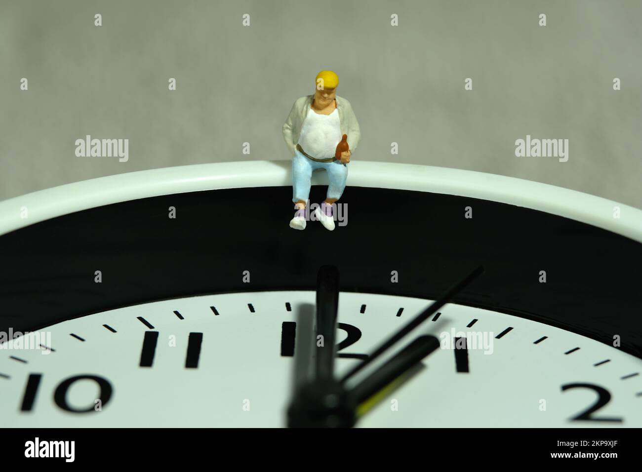 Miniature people toy figure photography. Fat men worker take a break ...