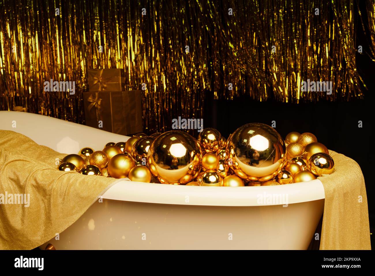 Bathtub full of golden balls. Vintage bright bathroom decorated with ...