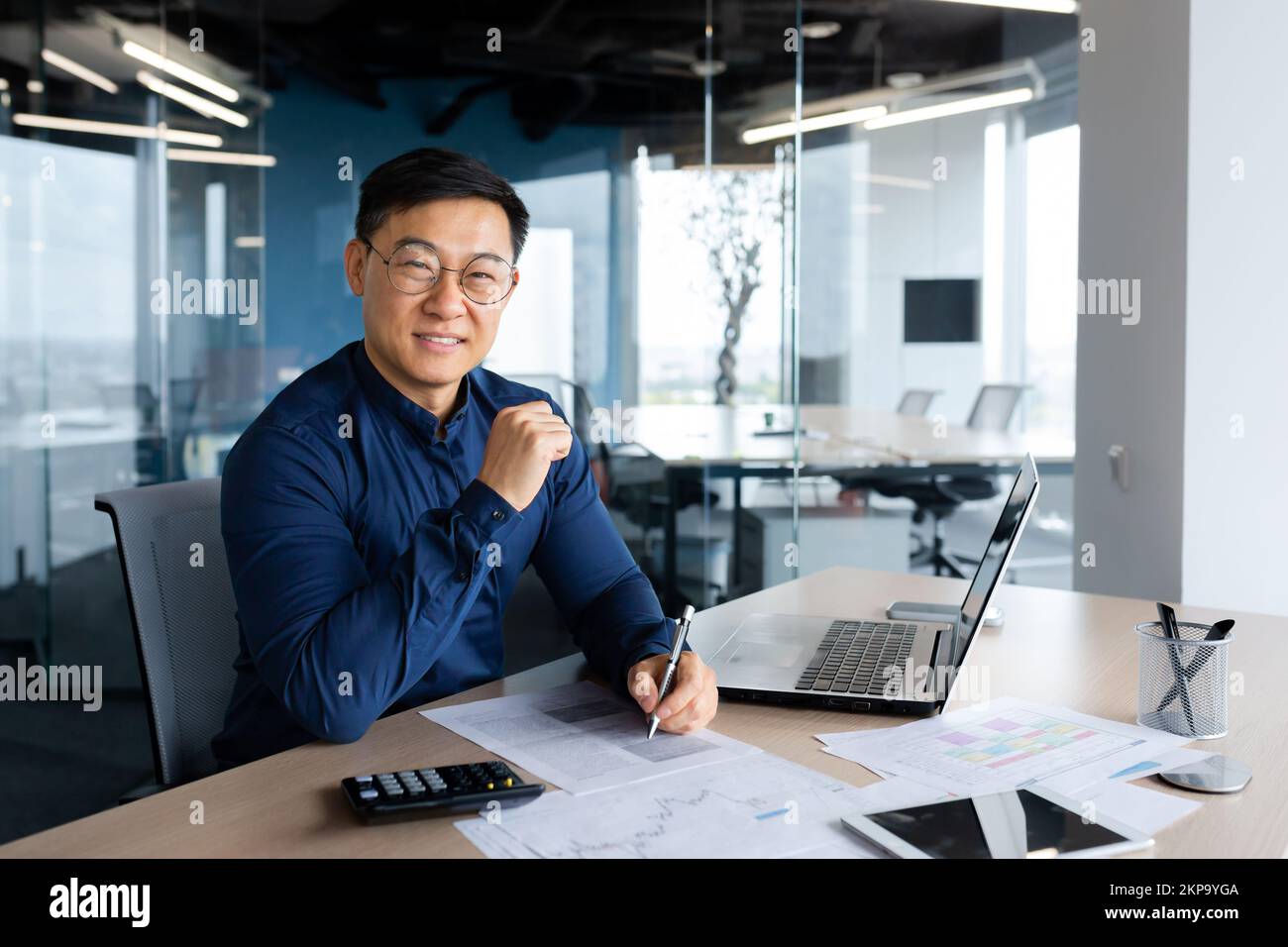 Working at his desk looking at notice hi-res stock photography and ...