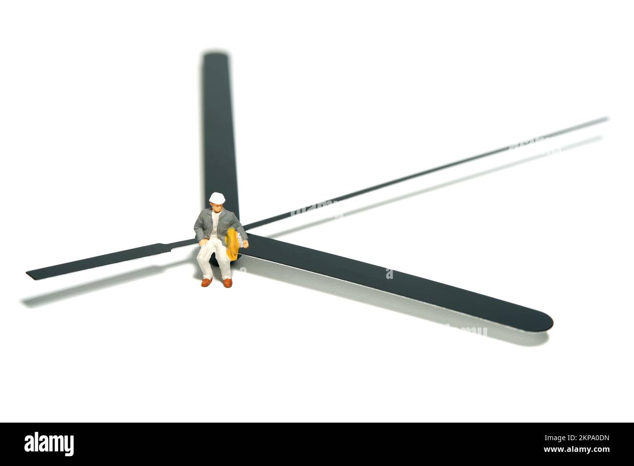 Miniature people toy figure photography. A men contractor take a break ...