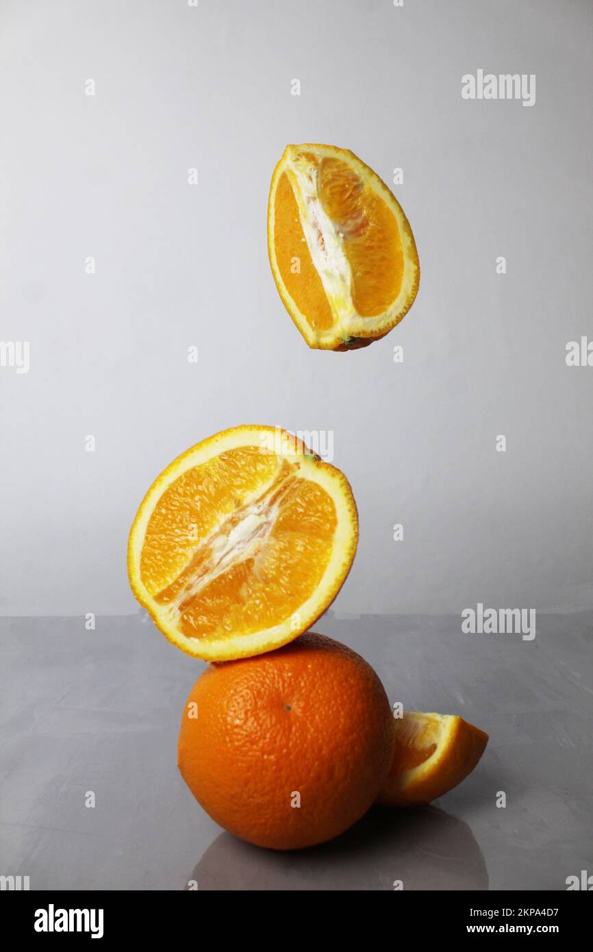 orange fruits citrus oranges flying falling arugula orange on a gray ...