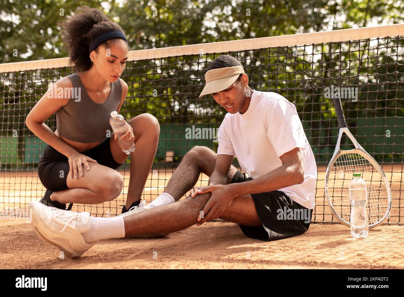 Young man suffering from pain after knee trauma Stock Photo - Alamy