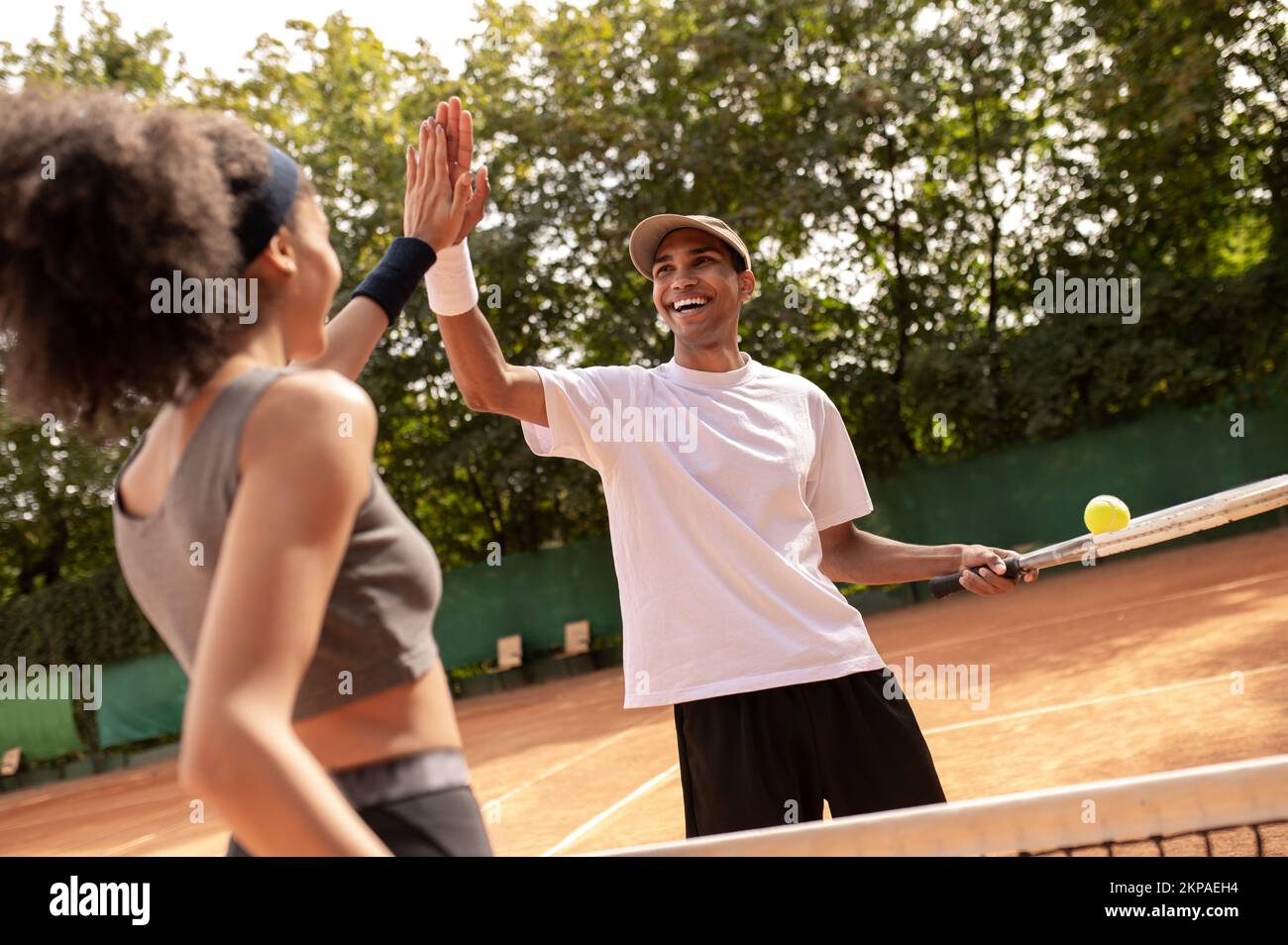 Two tennis players looking exciting and cheerful Stock Photo - Alamy