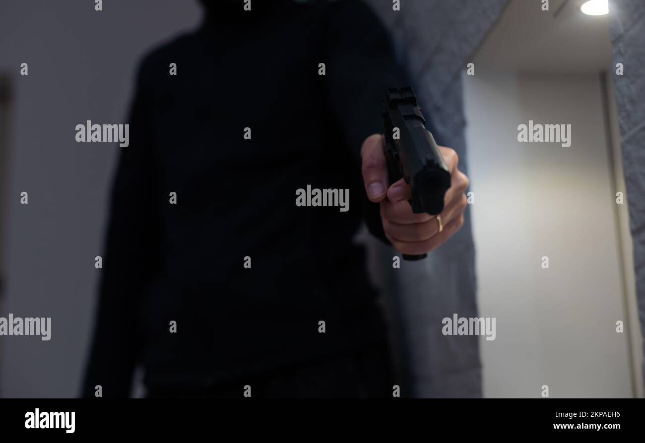 Threat of firearms. Muzzle of gun in man's hand is pointed at camera ...