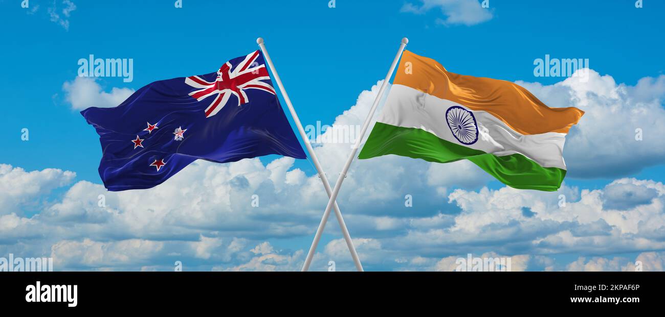 two crossed flags India and New Zeeland waving in wind at cloudy sky ...