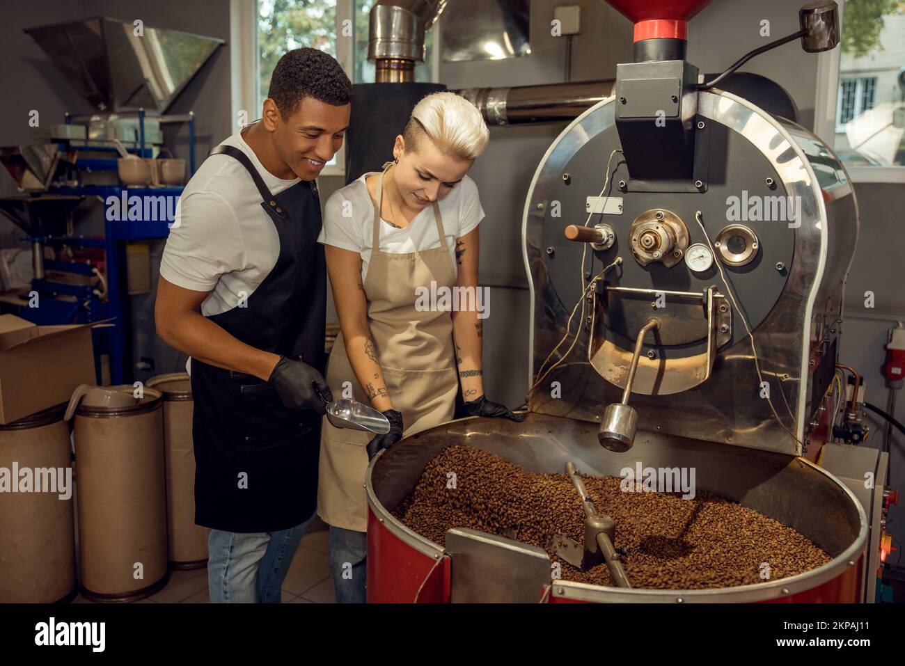 Professional roasters overseeing the coffee roasting process Stock ...