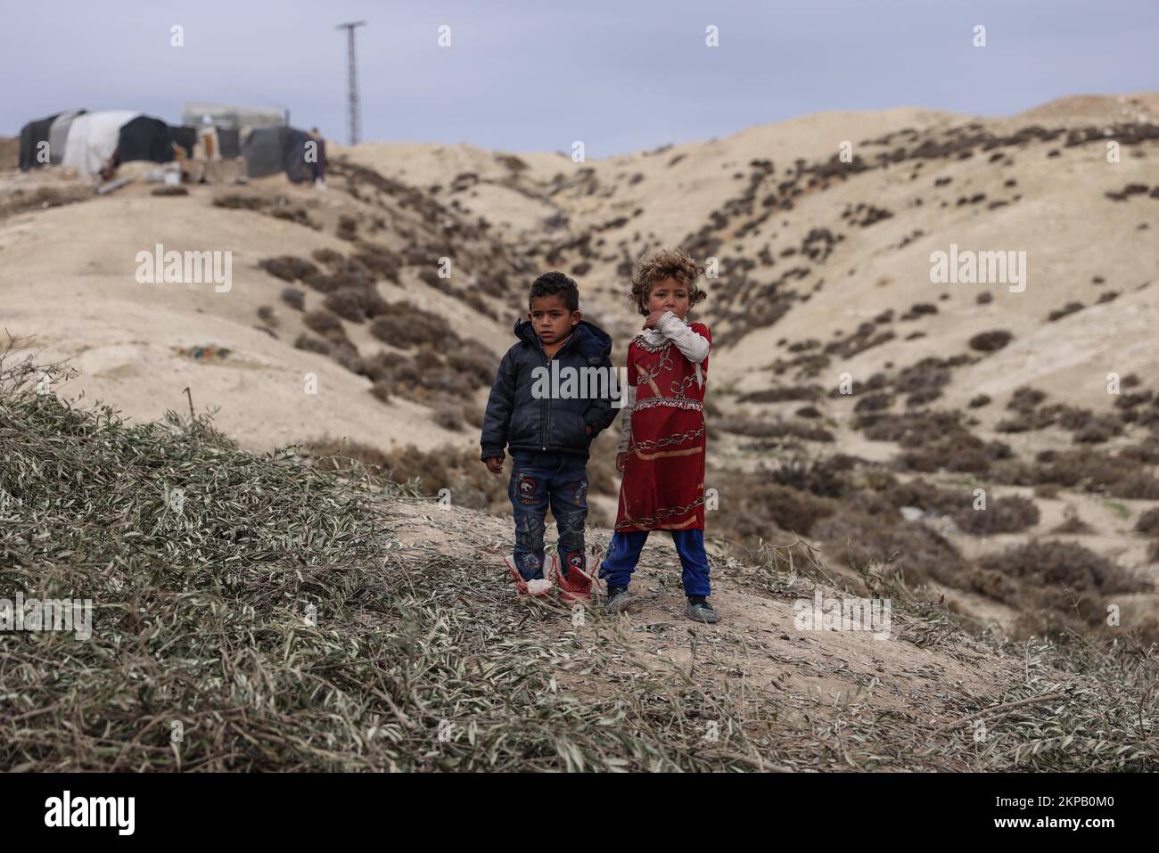28 November 2022, Syria, Azaz: Syrian children stand at Bersaya refugee ...