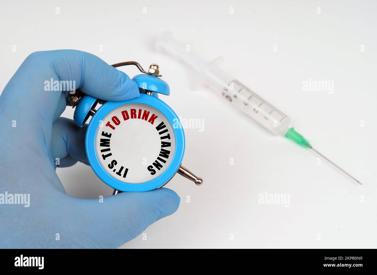 Medicine concept. There is a syringe on the table, an alarm clock in ...