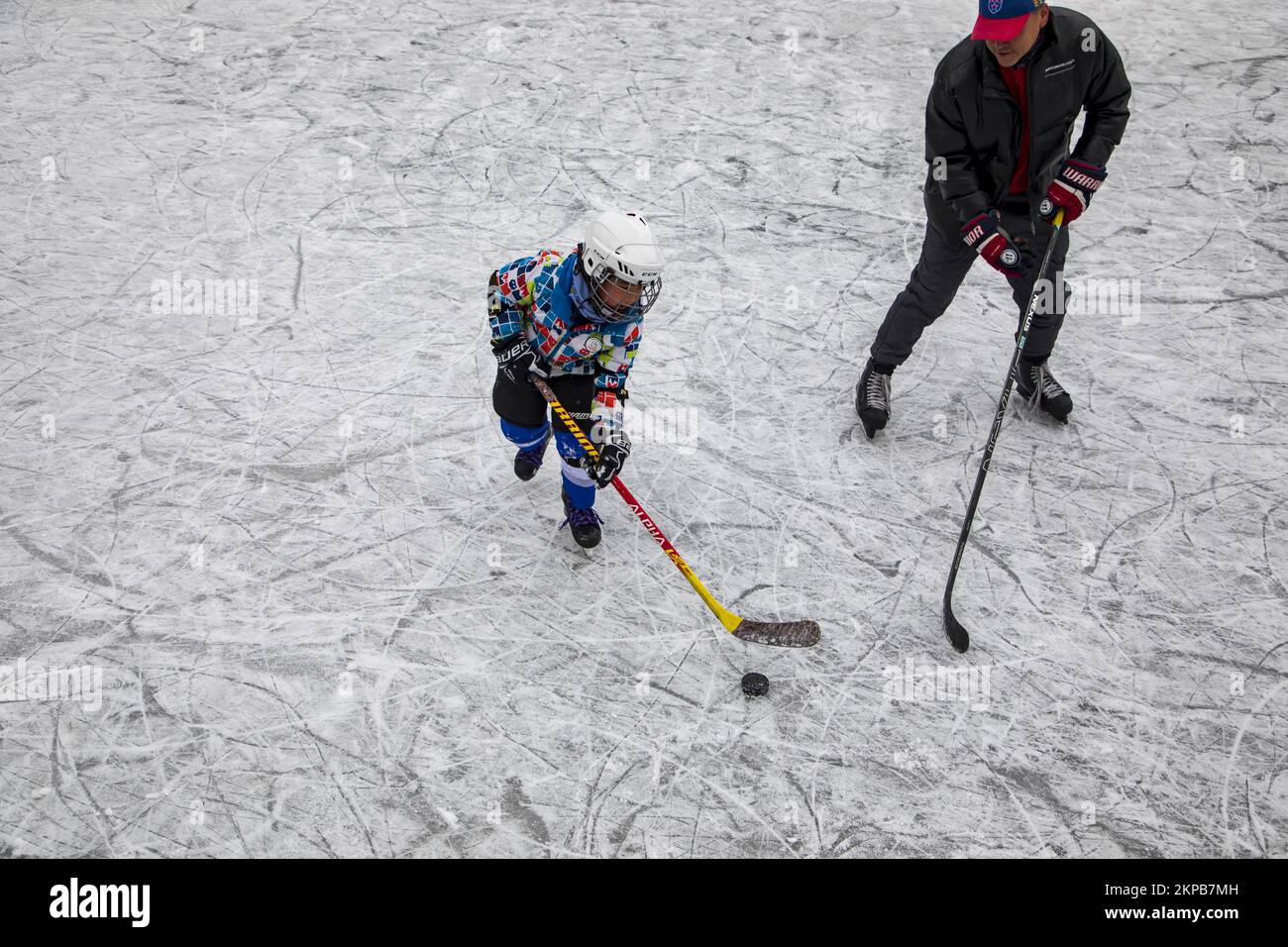 A boy is learning to play ice hockey on the Beishanxi Lake in Jilin ...